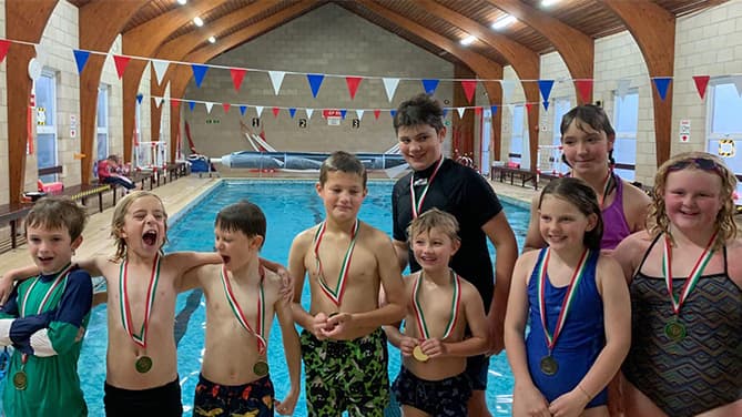 Young swimmers raise funds for pool and friend with rare condition ...